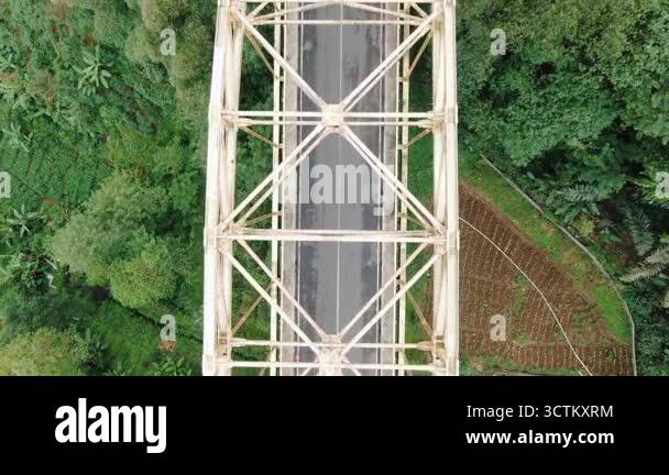 aerial view of metal construction and yellow arch bridge surrounded by ...