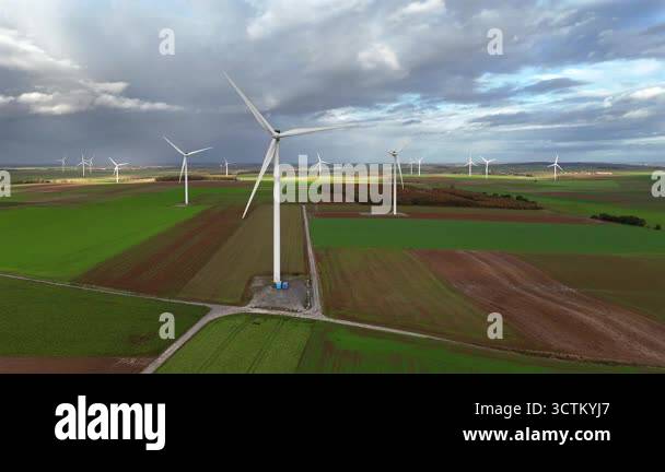 Aerial view of a large wind farm with multiple turbines turning in ...