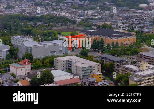 Aerial view of Kyoto, Japan, featuring a large orange torii gate ...
