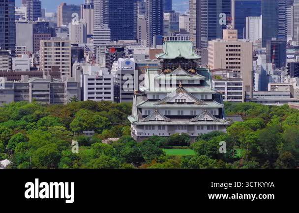A slow pan reveals Osaka Castle with its green roof and golden accents ...