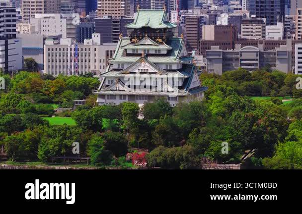 Aerial view of Osaka Castle with its green roof and golden accents, set ...