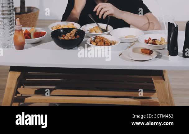 a woman is eating a delicious chicken in the kitchen Stock Video ...