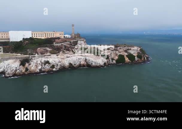 Smooth aerial view of Alcatraz Island with its penitentiary, lighthouse ...