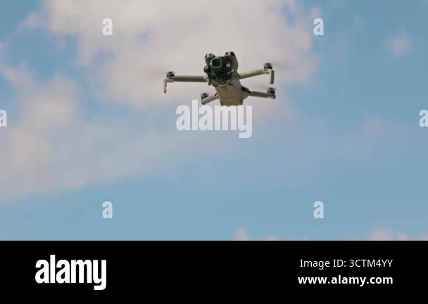 DJI Mini 5 Pro drone gently landing on a hand, showcasing modern drone ...