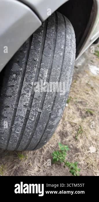 heavily worn car tires. Worn old tires on a car close-up. Vehicle tire ...