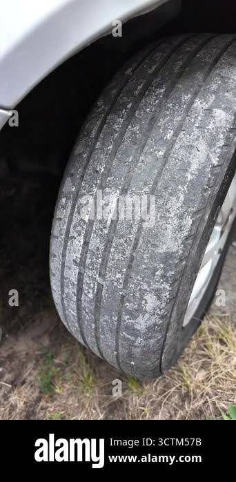 heavily worn car tires. Worn old tires on a car close-up. Vehicle tire ...
