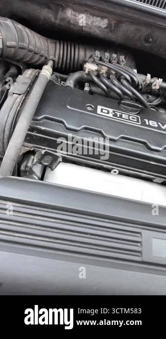 Mechanic tightening bolts on car engine's camshaft cover using socket ...