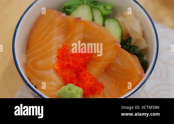 Close-up of colorful sashimi don served in a traditional Japanese bowl ...