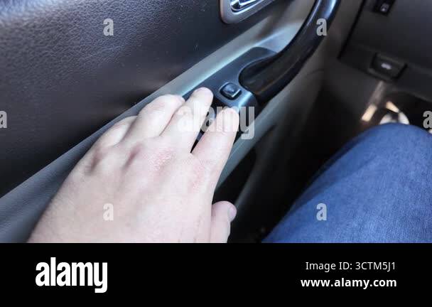 analog window lift buttons. man opens window in car. old buttons in car ...