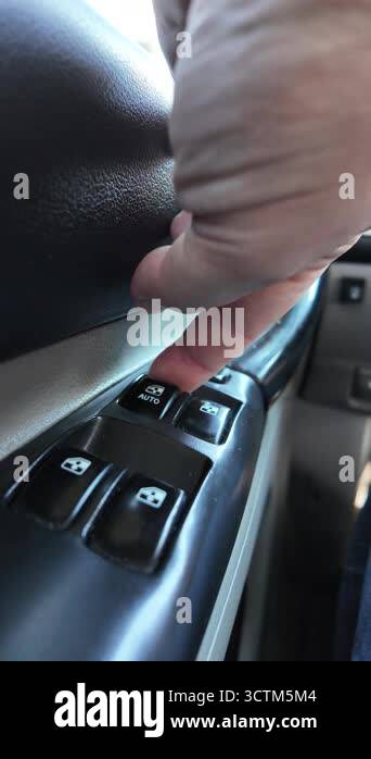 analog window lift buttons. man opens window in car. old buttons in car ...