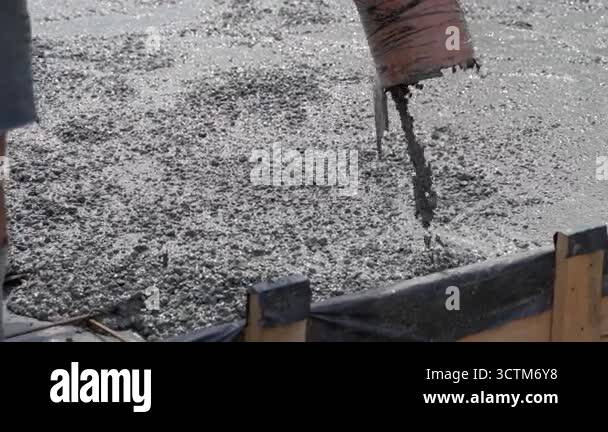 Automatic supply of liquid concrete through a pipe. Construction site ...