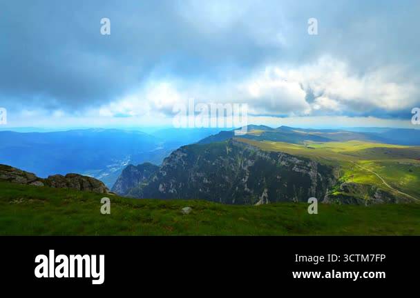 Steep cliffs and sunlit slopes in dramatic mountain scene in Romania ...