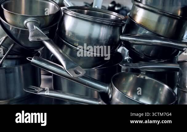 Sets of different sized cooking pots in restaurant. Kitchenware for ...