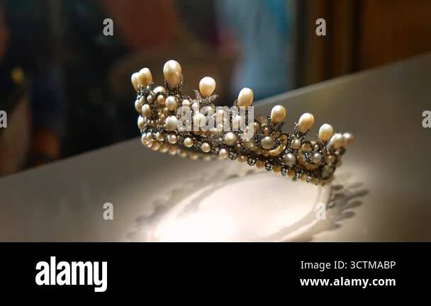 Close-up of a pearl and diamond tiara displayed inside a museum ...