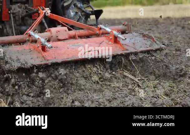 Tractor plowing muddy rice field, mud in the paddy, showing soil ...