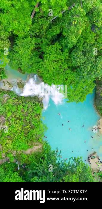 Aerial view of a vibrant turquoise river cascading into natural pools ...