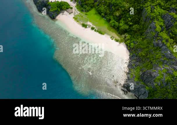A beautiful white sand beach with serene coastal waters. Tapiutan ...