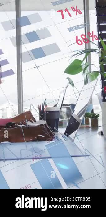 Business data and charts animation over diverse team working on laptops ...
