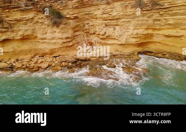 Detailed texture of coastal cliff face with crashing waves in Kefalonia ...