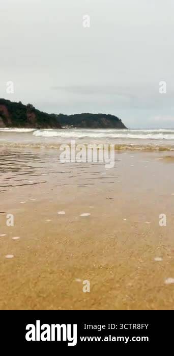 Rodiles Beach in Villaviciosa, Spain, under cloudy weather with soft ...