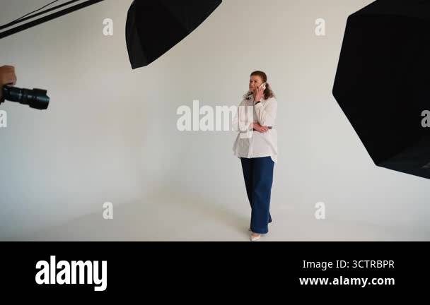 Professional photographer capturing a beautiful model talking on her ...
