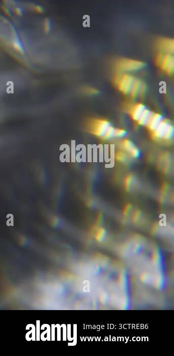 Vertical video. Visual crystal. Blur twinkle rainbow. Defocused yellow ...