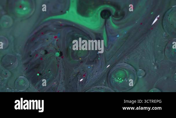 Oil stream. Bubble fluid. Defocused green purple red color round ...