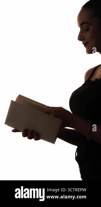 Vertical video. Reading silhouette. Knowledge study. Smart hobby. Dark ...