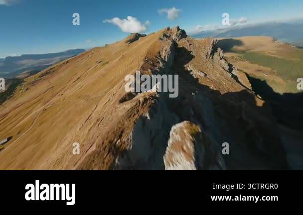 FPV drone flying close to the sharp mountain cliffs of Seceda, Italy ...
