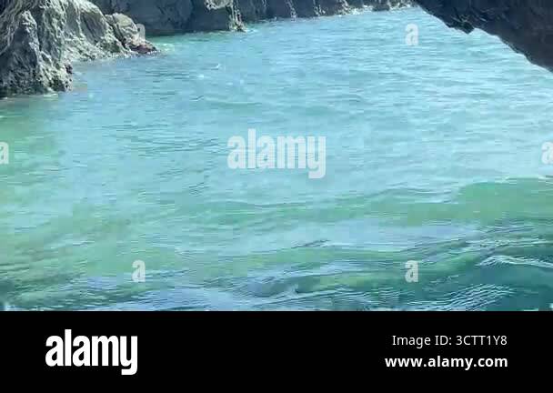 Calm Blue Waters Gently Lap Against Rocky Shores in a Serene Coastal ...
