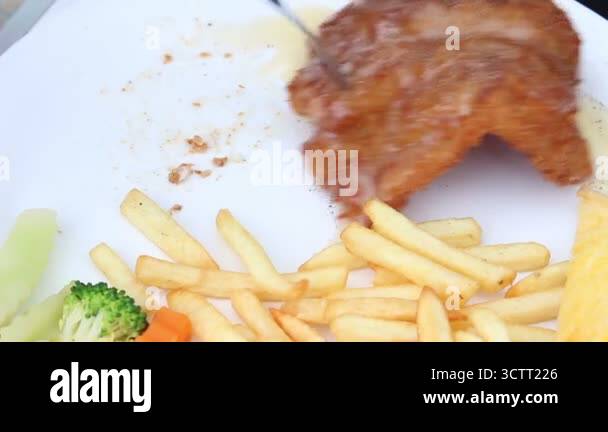cutting fried fish with knife and fork Stock Video Footage - Alamy