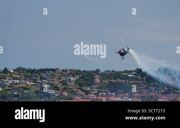 Military helicopter flying at low altitude over residential area ...