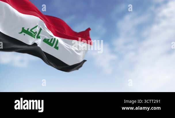 Republic of Iraq national flag waving on a clear day. Three horizontal ...