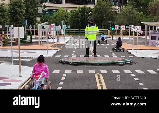 Cuenca, Ecuador: May 3 2025: Long shot of children driving small go ...