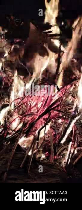 Front view close-up video of fire flames burning against a pure black ...