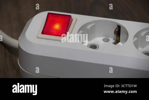 White electric portable socket with red power and on indicator, zoom ...