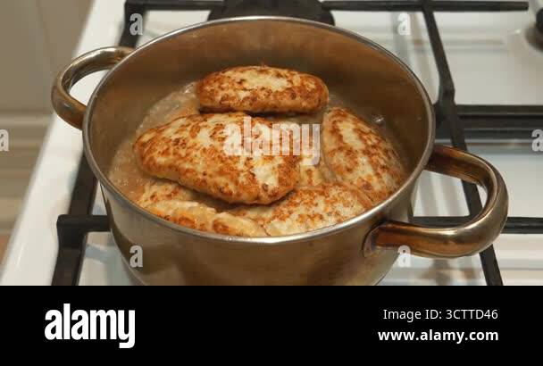 Cooking, stewing meat. Meat cutlets are stewed in saucepan. Meat ...