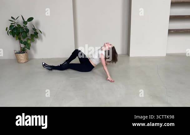 woman performing an elegant high heels dance routine in a bright ...