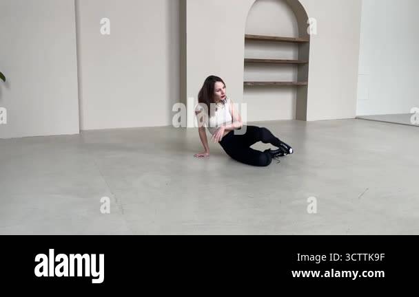 woman performing an elegant high heels dance routine in a bright ...