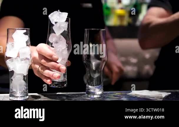 three glasses on the bar Throw ice cubes in empty glass. Ice Cubes ...