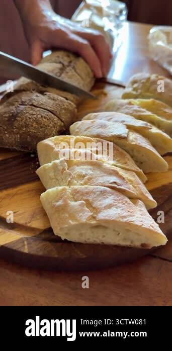The chef slices fresh bread. Filmed on a high-speed camera at 1000 fps ...