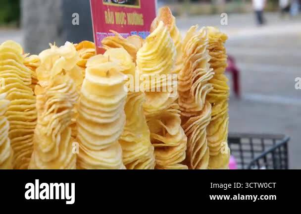 tornado potatoes, a popular Korean street food, are displayed on a ...