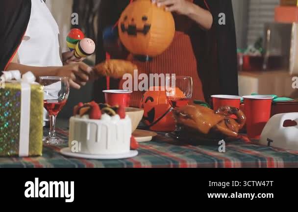 happy halloween. young woman in a red costume and hat holding a pumpkin ...