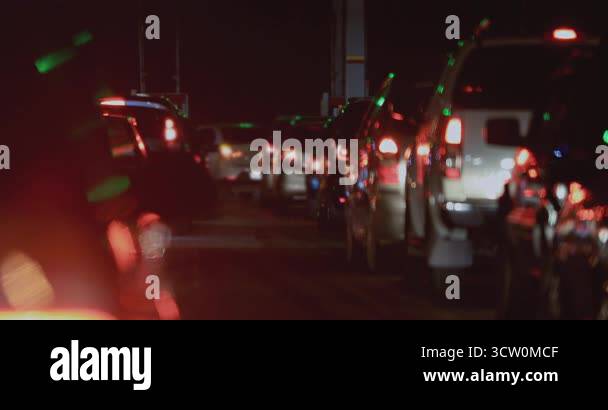 Traffic jam at night with long rows of cars and brake lights glowing ...