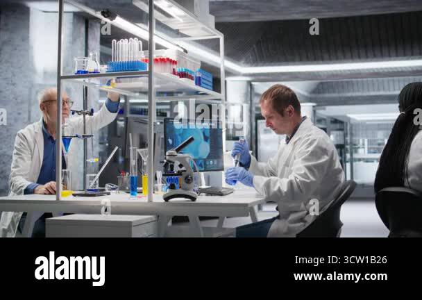 Scientist uses pipette to transfer droplet of sample into jar during ...