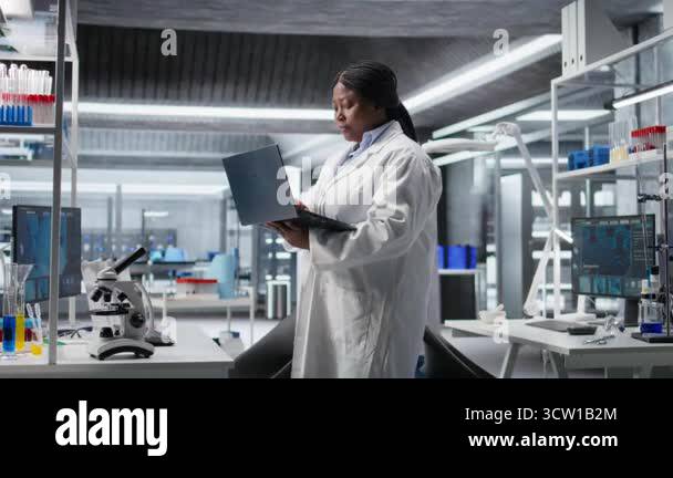 African American woman scientist works in a modern laboratory ...