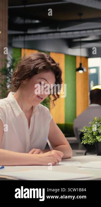 Vertical Video Black female applicant signing the new employment ...