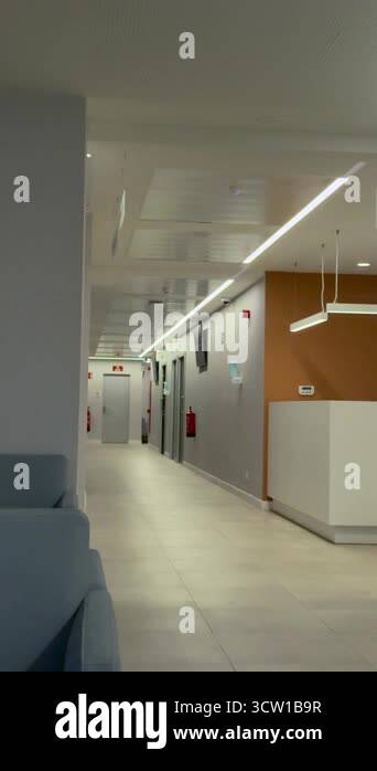 Modern and clean interior of an empty hospital or clinic hallway. Long ...
