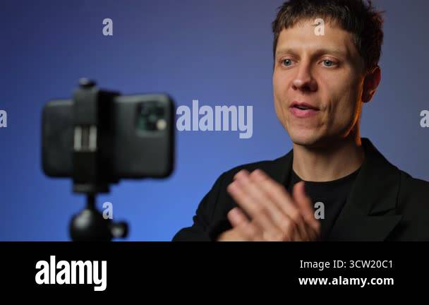 Young man in suit dramatically speaking to camera about success, wealth ...