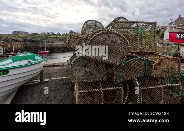 Fishing traps and boats at Crail Harbor Stock Video Footage - Alamy